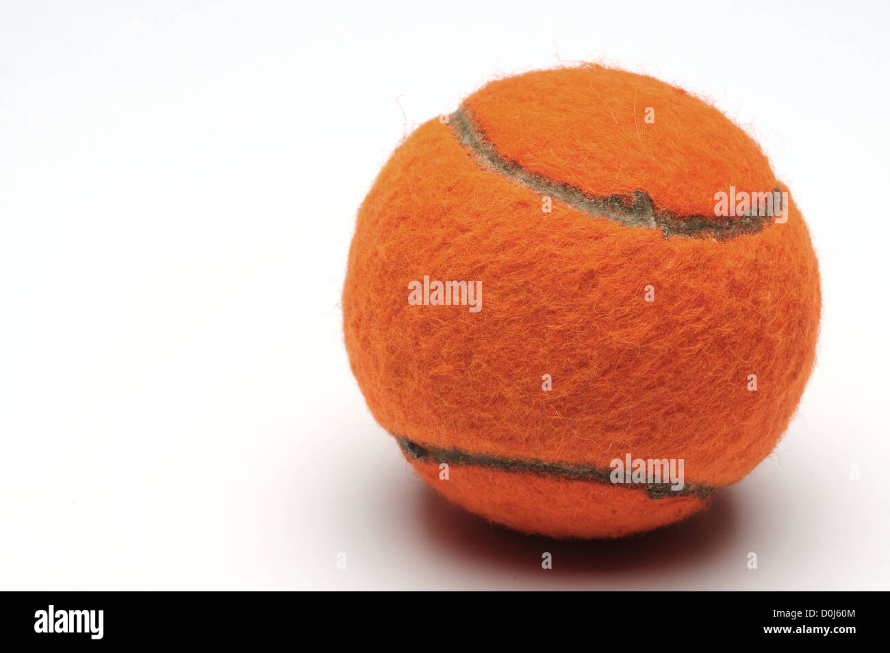 Orange color tennis ball Stock Photo - Alamy