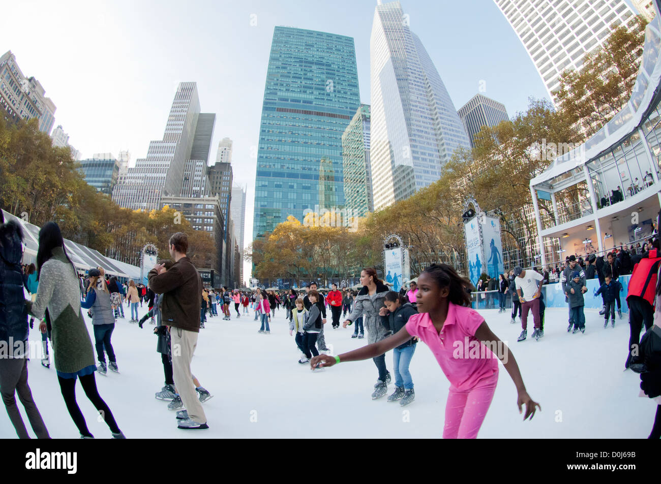 Skaters maneuver the packed Pond at Bryant Park ice skating rink in New ...