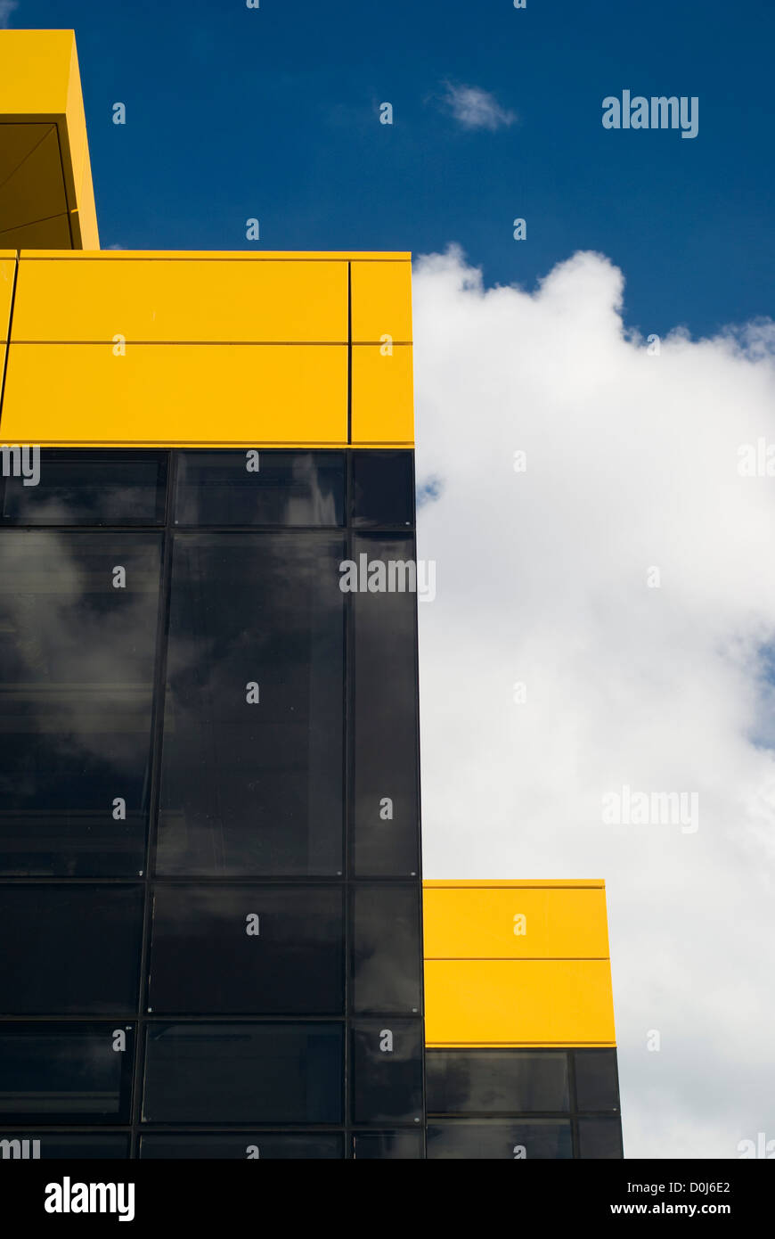 modern yellow building with clouds Stock Photo - Alamy