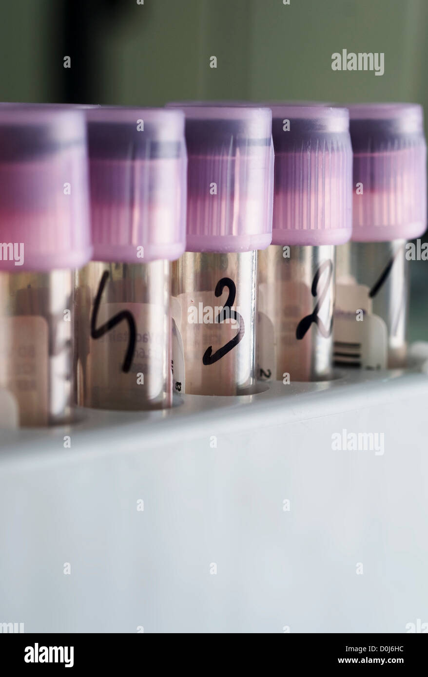 violet test tubes with numbers; shallow depth of field; focus on 3rd ...
