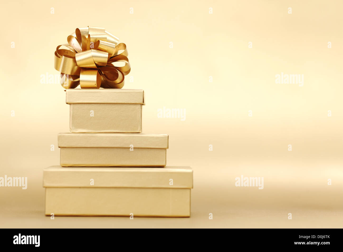 golden christmas gifts on gold background Stock Photo - Alamy