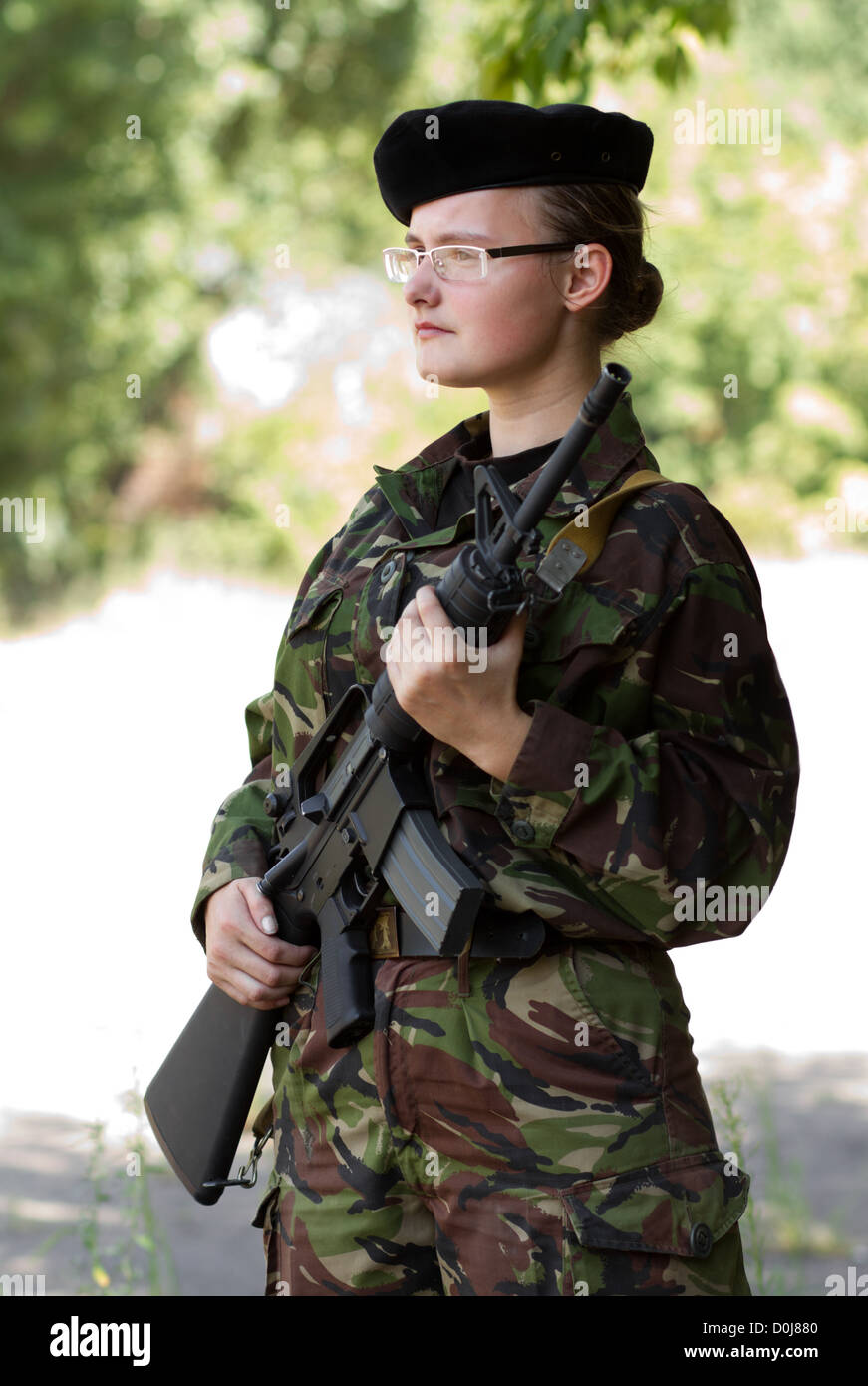 Young girl with automatic rifle standing on guard Stock Photo - Alamy