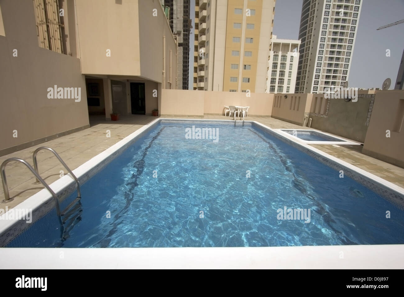 man in swimming pool at roof of apartment in Bahrain Stock Photo - Alamy