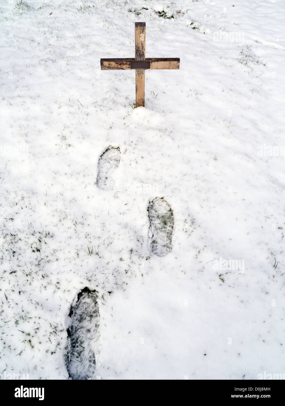 Footsteps and a cross in the snow at Radley Village church graveyard ...