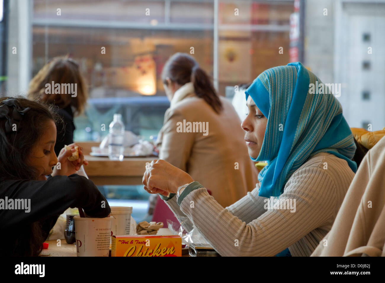 A young Muslim woman with her daughter sharing a meal Stock Photo - Alamy
