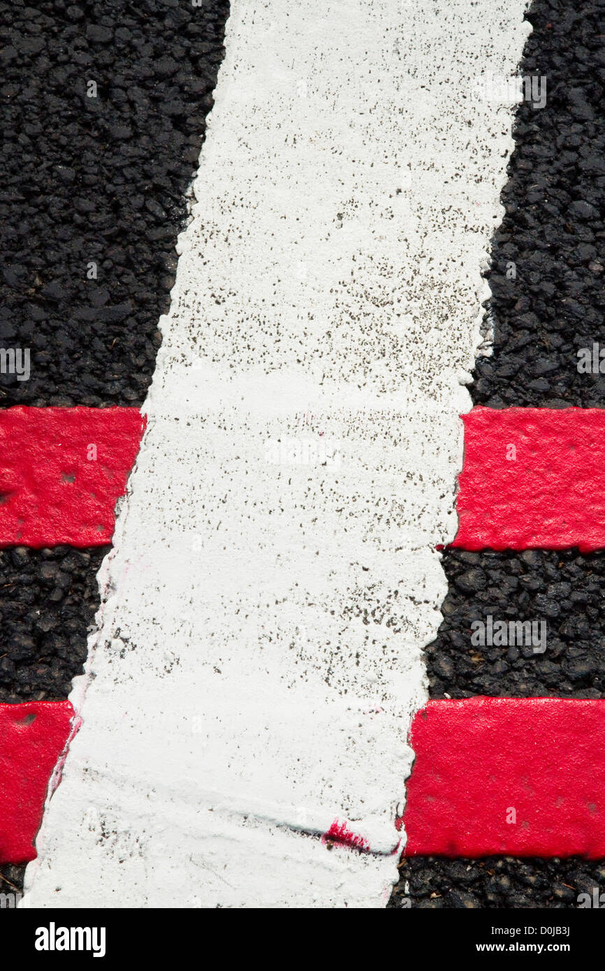 Graphic red and white lines to control traffic on a street leading into ...