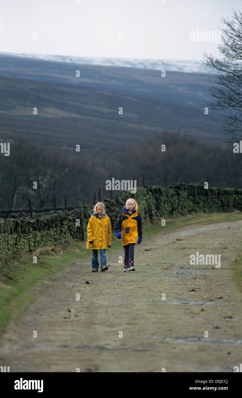 UK, Yorkshire, Peak District, two young girls walking along path Stock ...