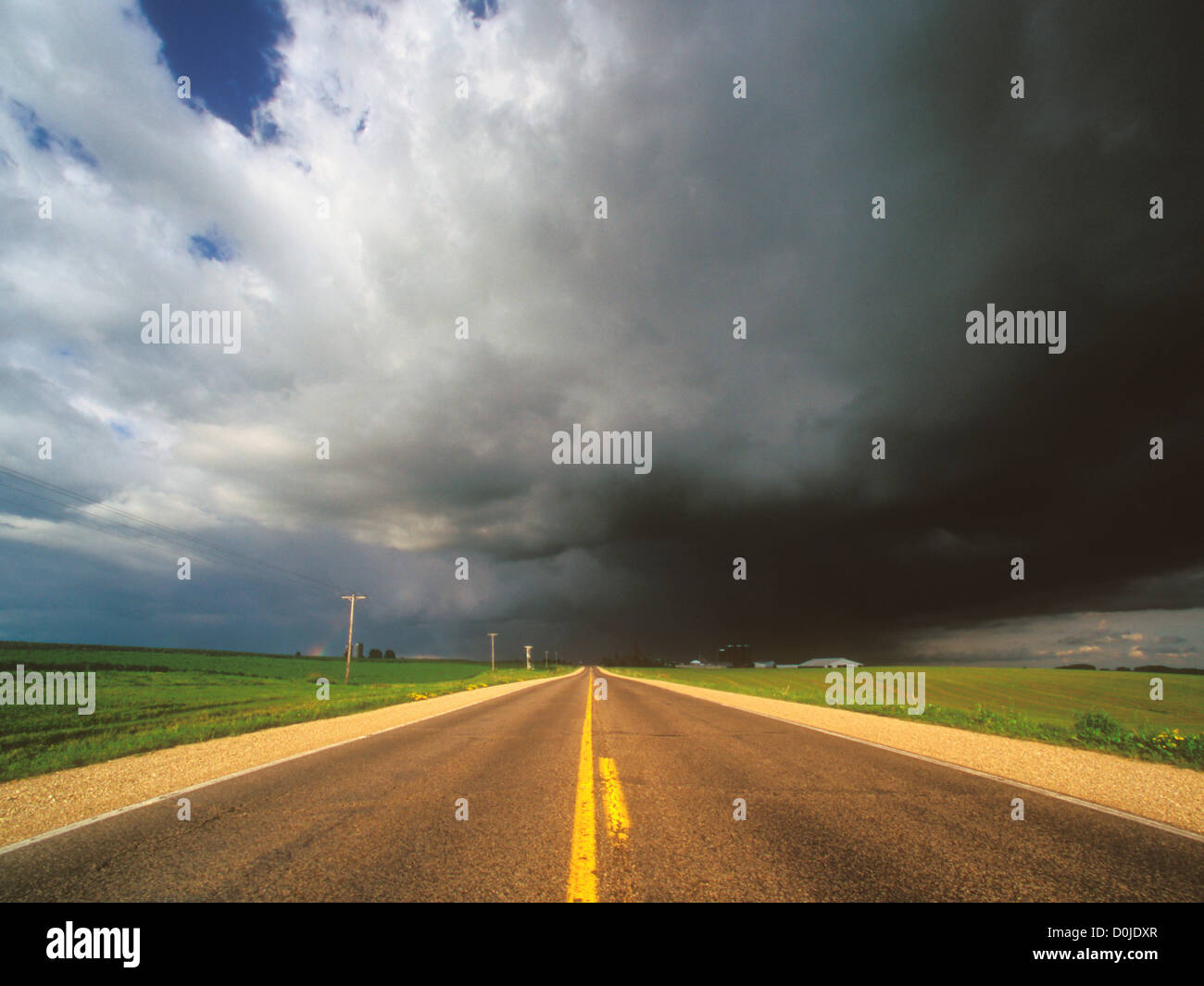 Rural Road to Infinity and a Thunderstorm Stock Photo - Alamy