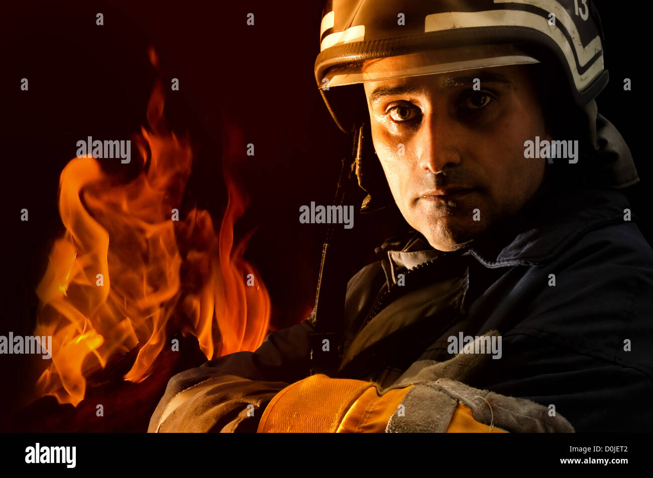 Portrait of a fireman with fire isolated in black Stock Photo - Alamy