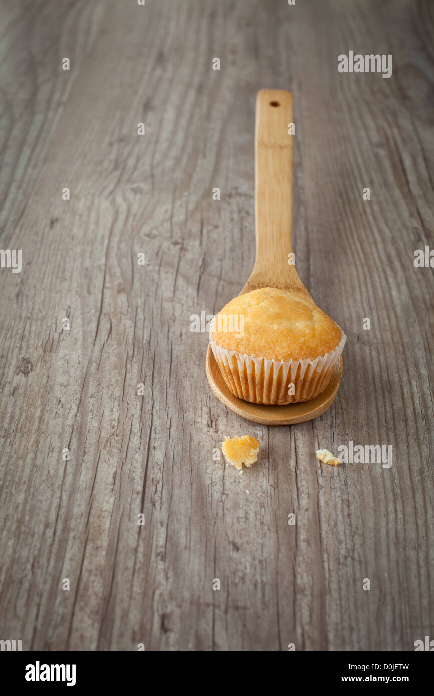 Tasty simple muffin on a wooden spoon Stock Photo - Alamy