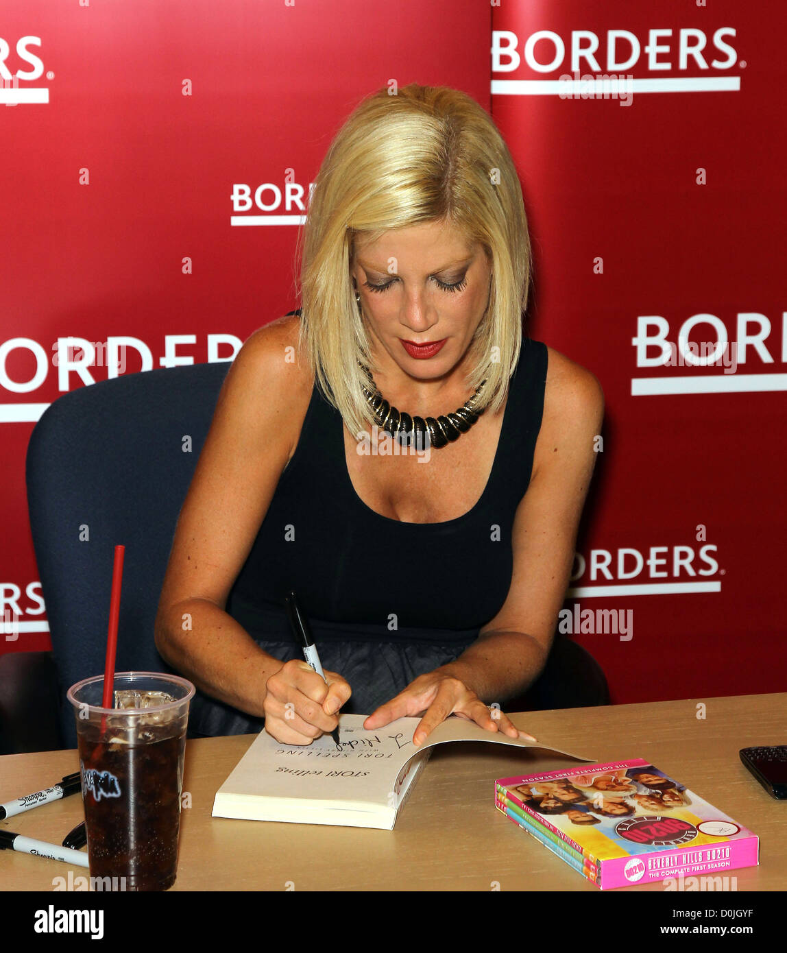 Tori Spelling signs copies of her book 'Uncharted Territori' at Borders ...