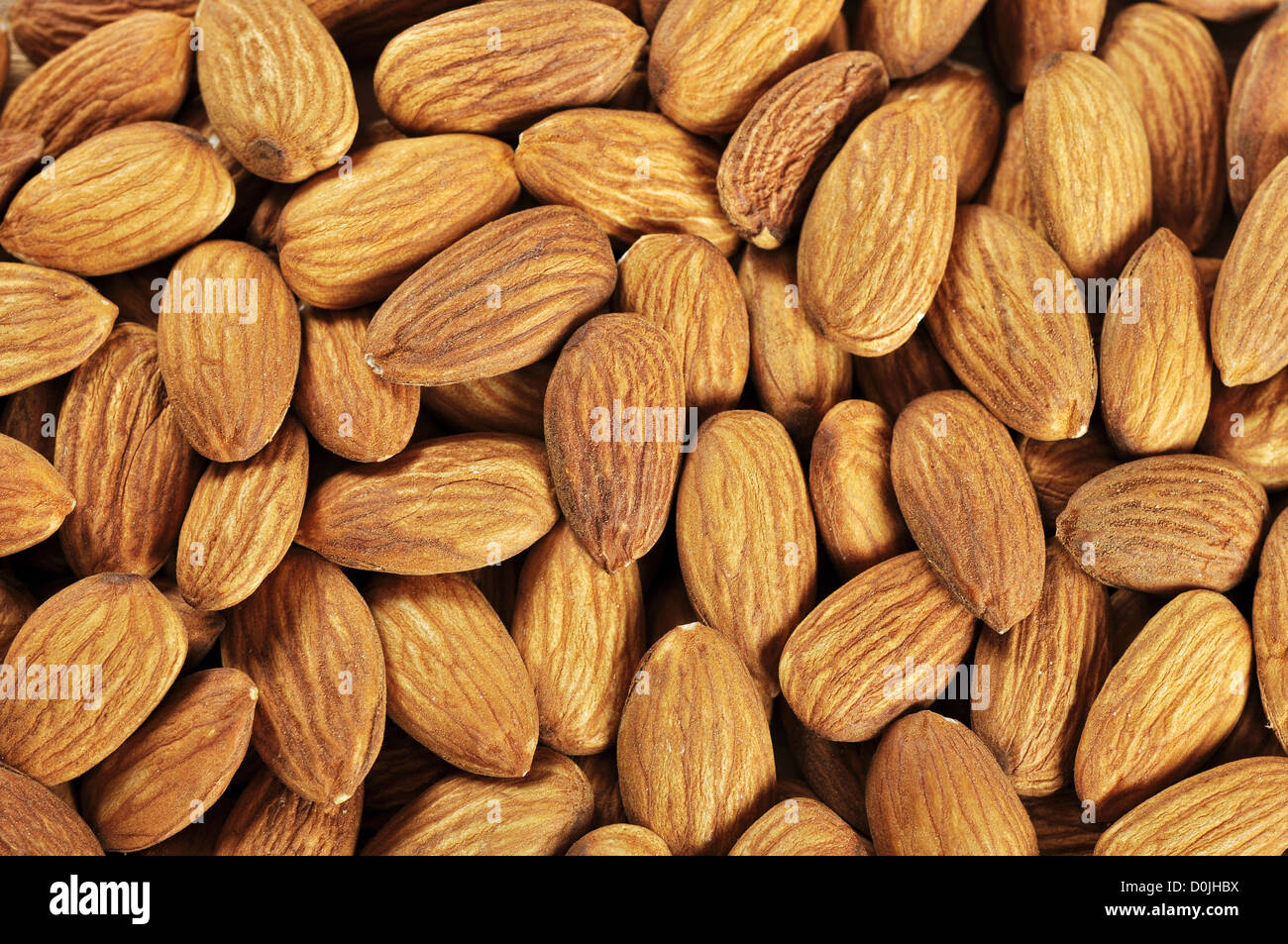 tasty almond nuts closeup background Stock Photo - Alamy