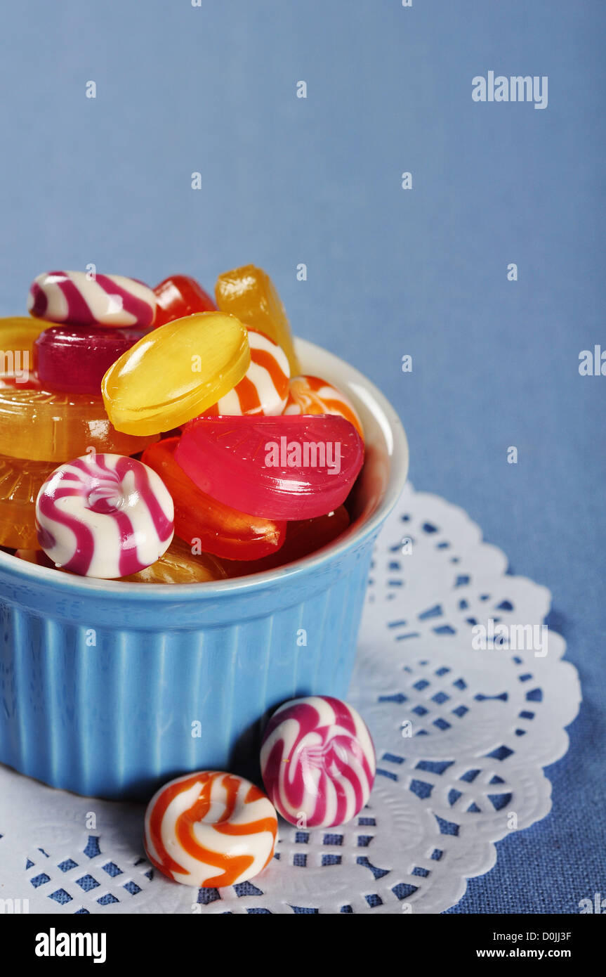 Colorful candy in a blue ceramic bowl closeup Stock Photo - Alamy