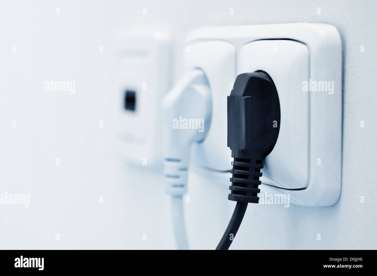 electric plug in a socket closeup. Small shallow DOF Stock Photo - Alamy