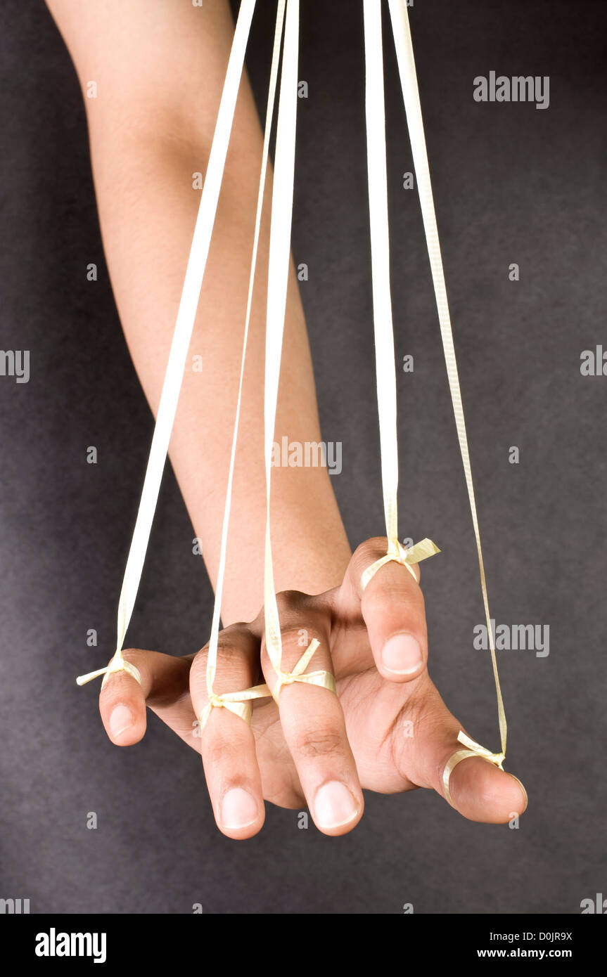 Close-up of a person's hand pulled by threads like a puppet Stock Photo ...