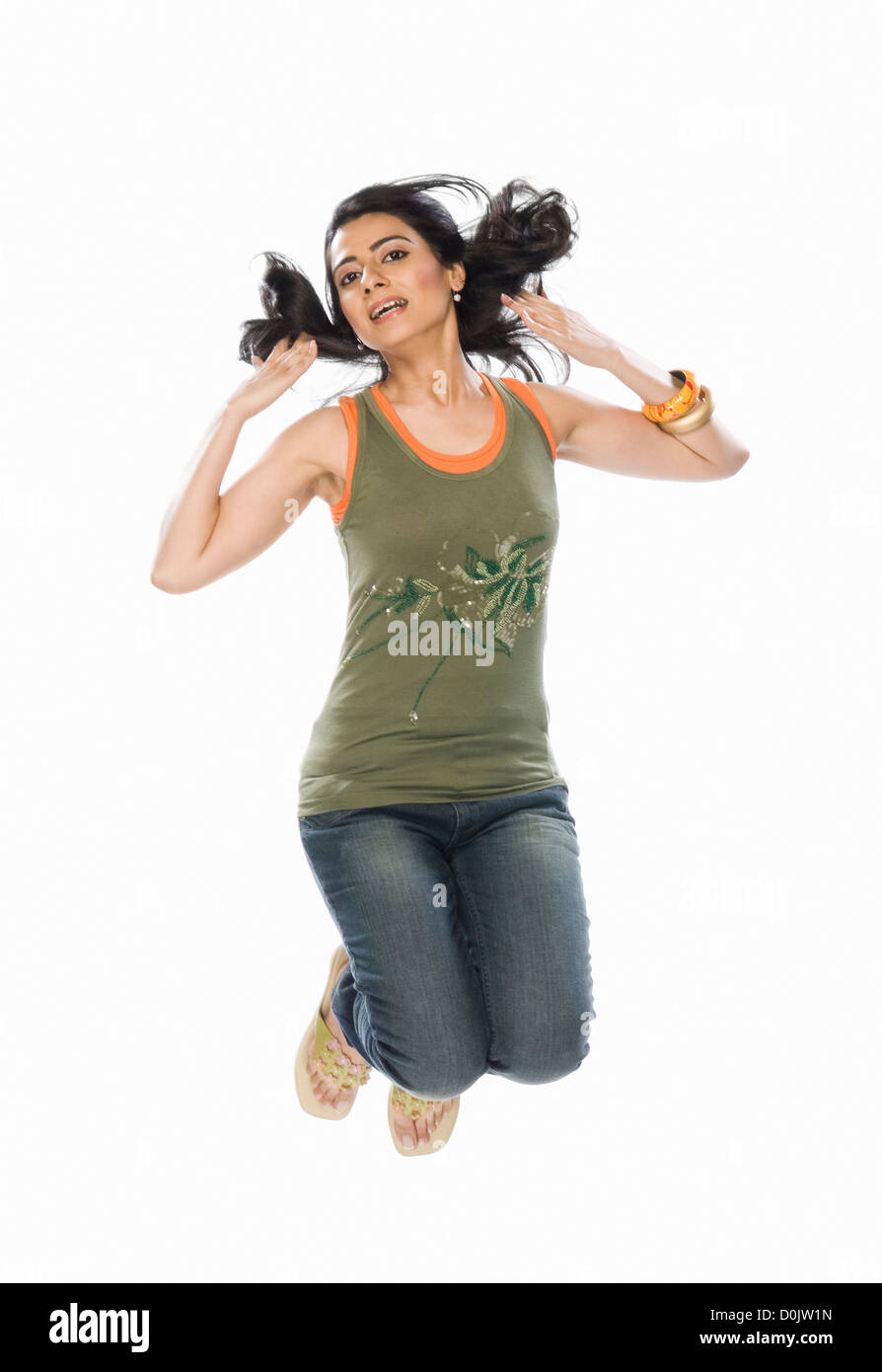 Portrait of a woman jumping Stock Photo - Alamy