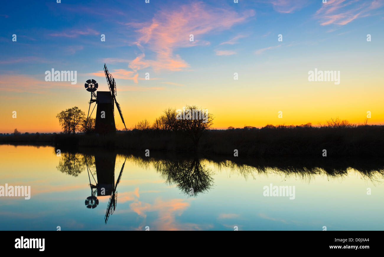 Turf Fen wind pump reflecting in the river Ant at sunset Stock Photo ...
