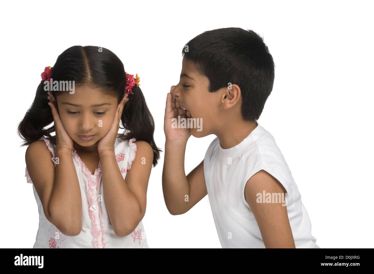 Girl covering her ears while her brother shouting Stock Photo - Alamy