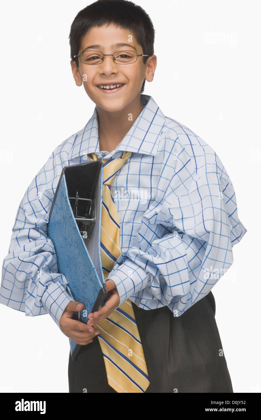 Portrait of a boy wearing oversized clothes and holding a file Stock ...