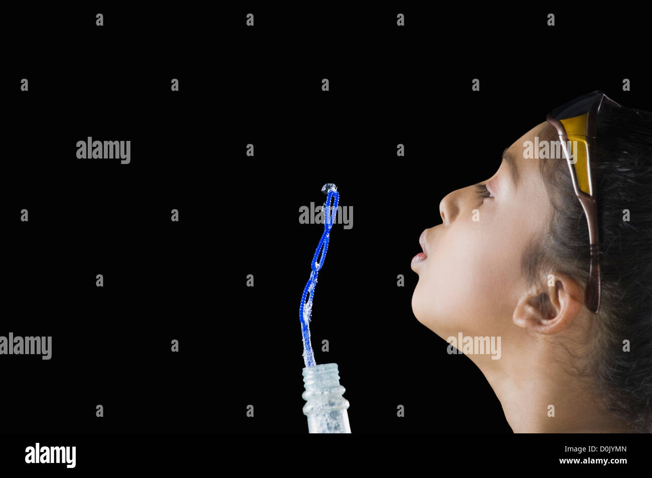 Side profile of a girl blowing bubbles Stock Photo - Alamy