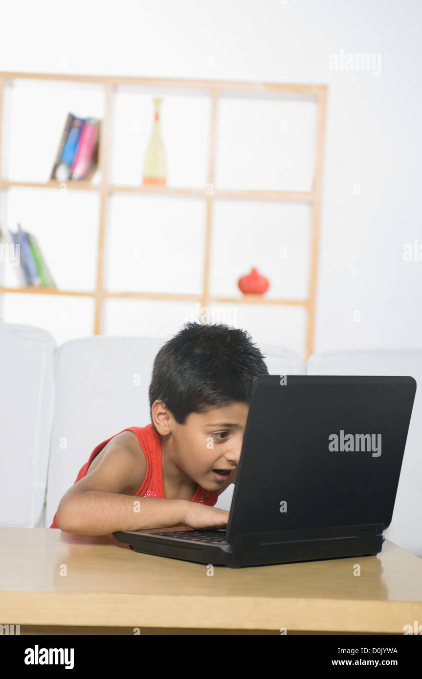 Boy using a laptop Stock Photo - Alamy