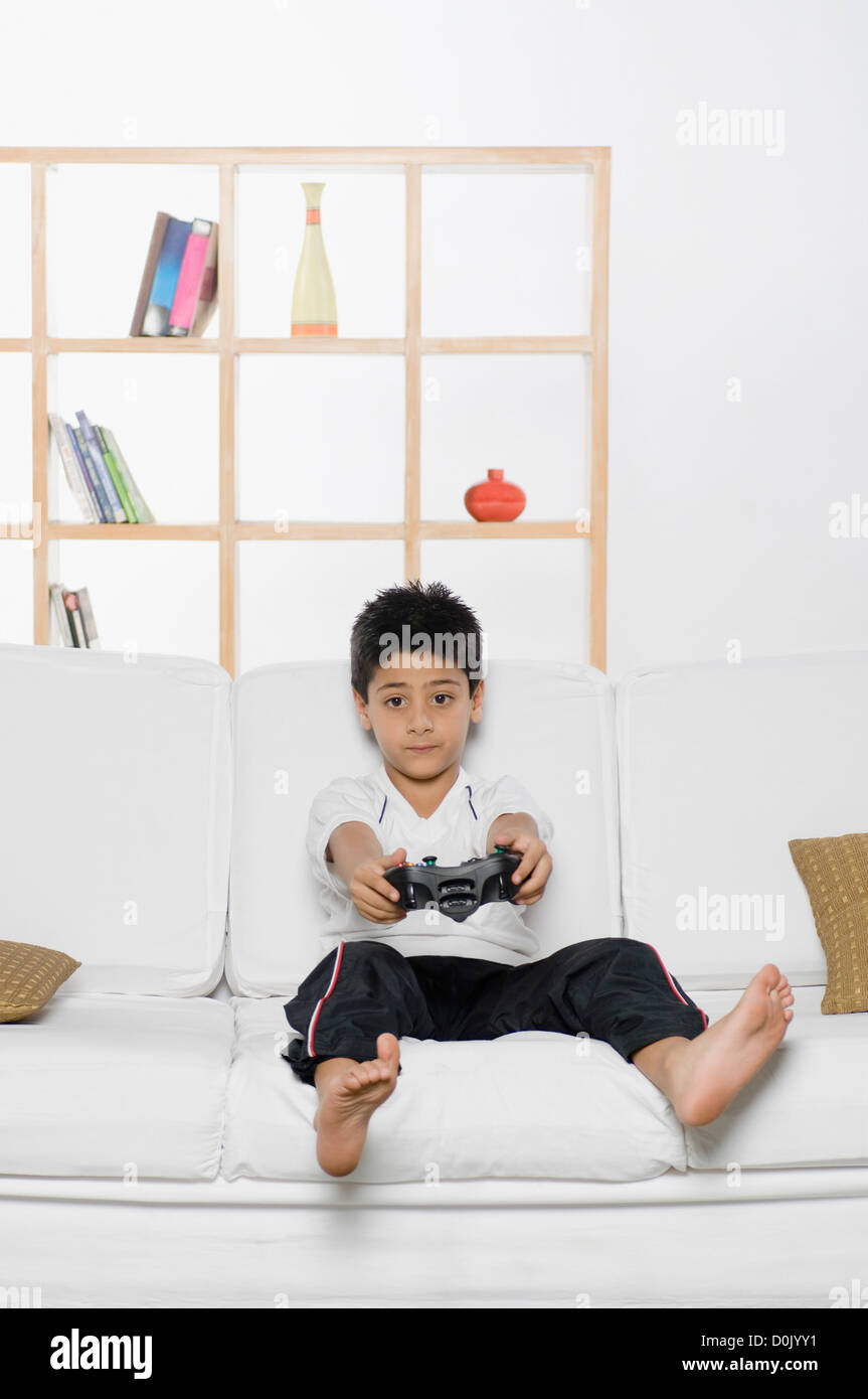 Boy playing handheld video game Stock Photo - Alamy