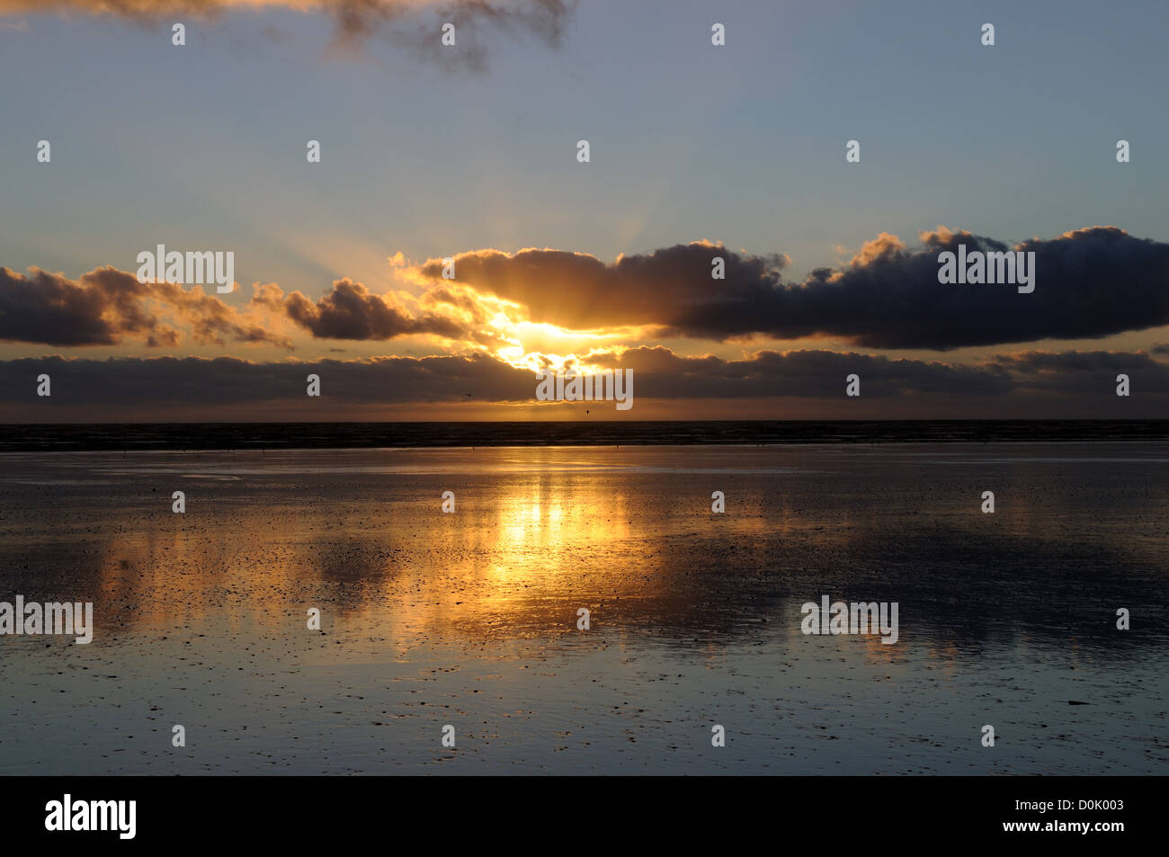 Winter sunset over reflected in Cefn Sidan Beach Pembrey Country park ...