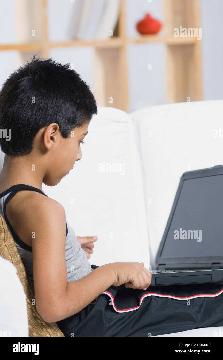 Boy using a laptop Stock Photo - Alamy