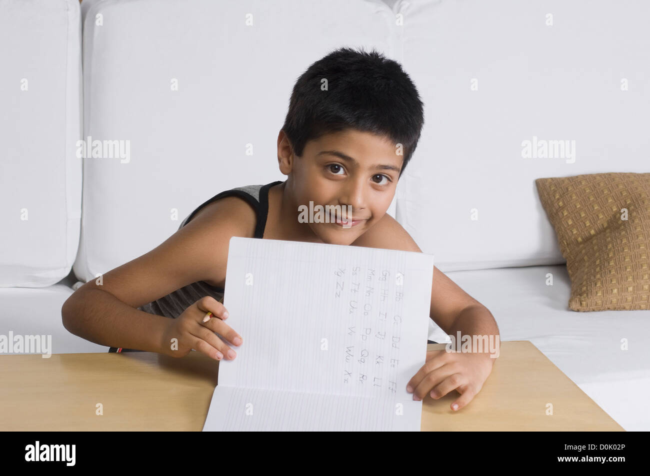 Portrait of a boy showing his notes Stock Photo - Alamy
