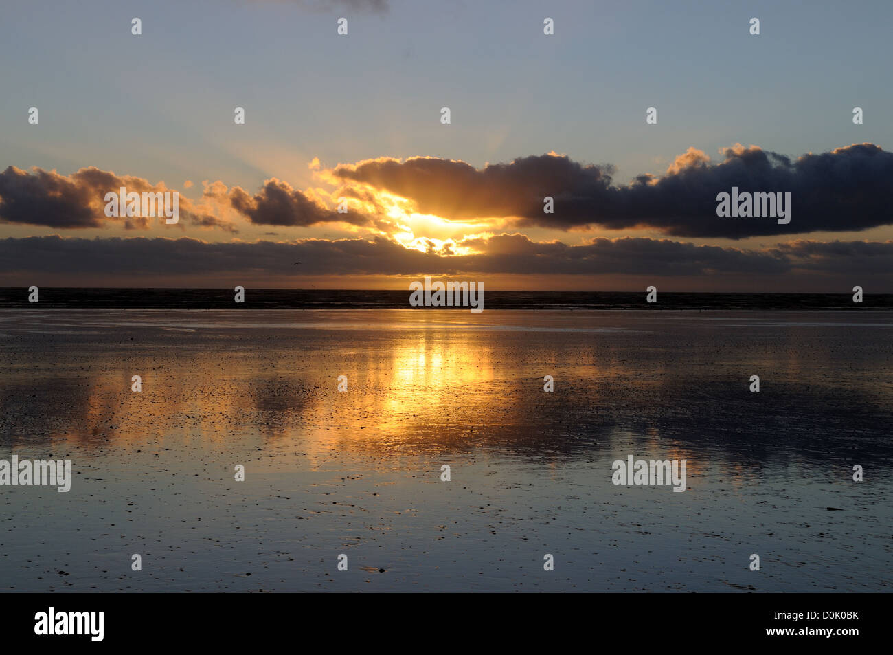 Winter sunset over reflected in Cefn Sidan Beach Pembrey Country park ...