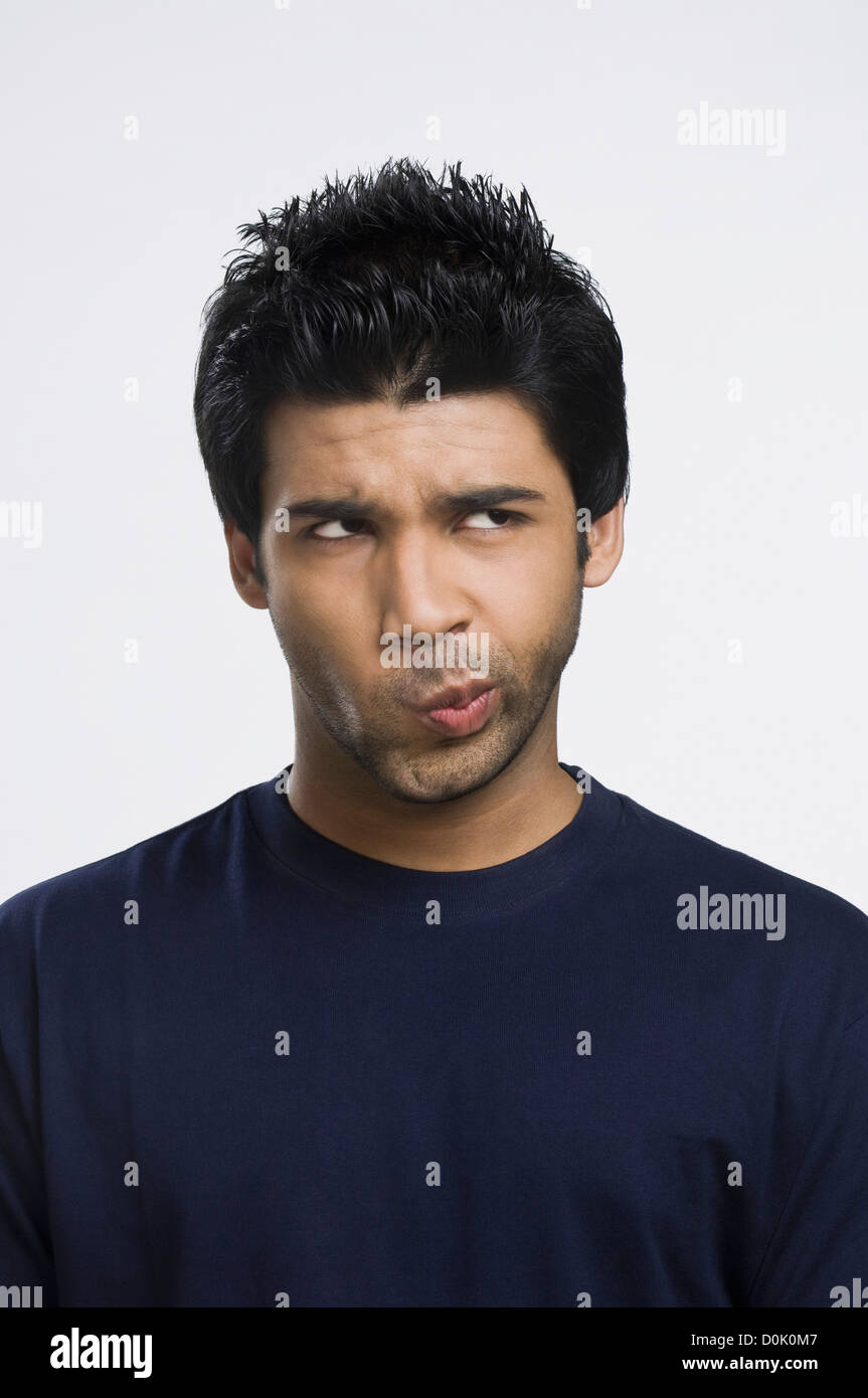 Man making a funny face and looking sideways Stock Photo - Alamy