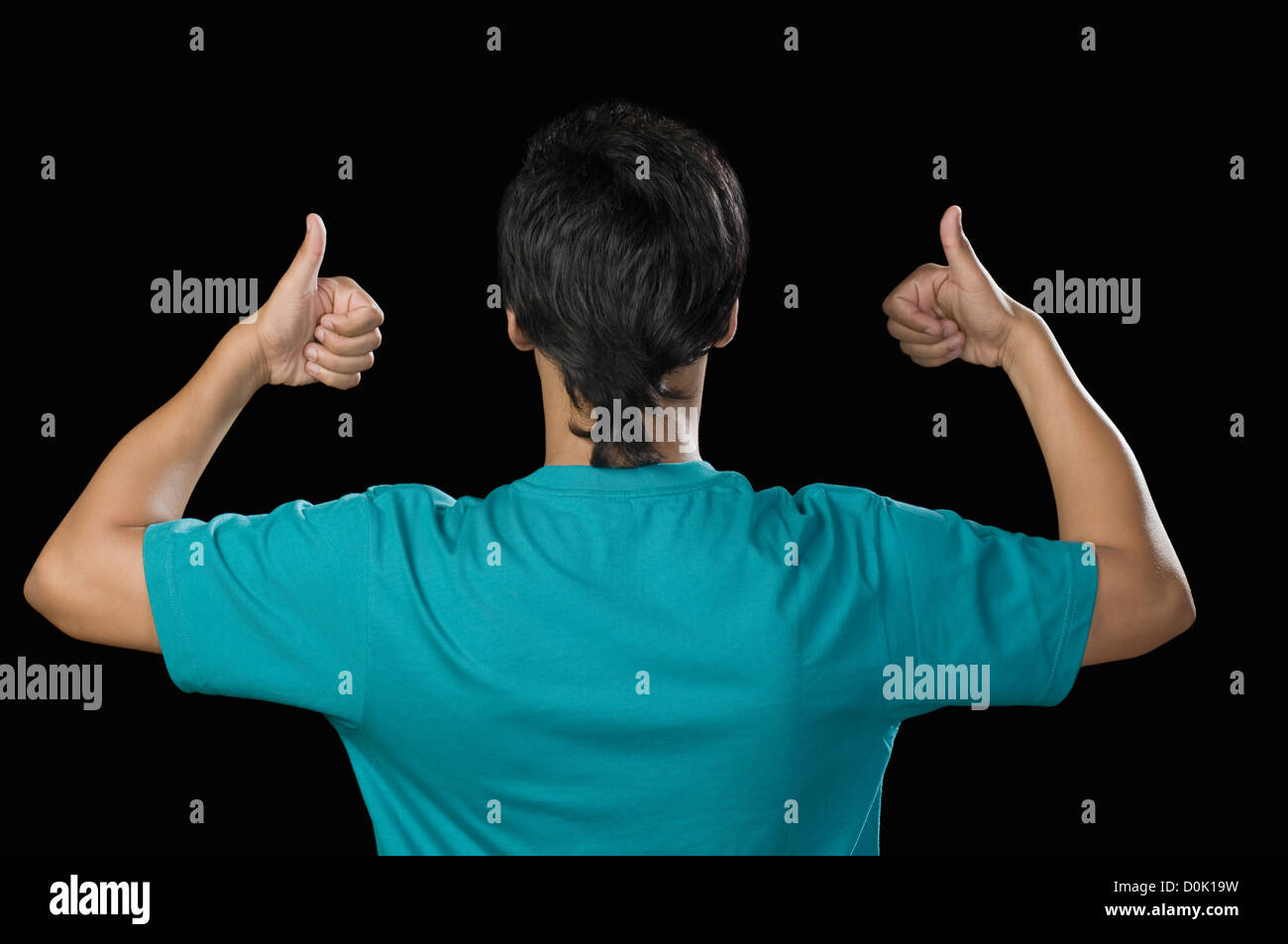 Rear view of a man showing thumbs up sign Stock Photo - Alamy