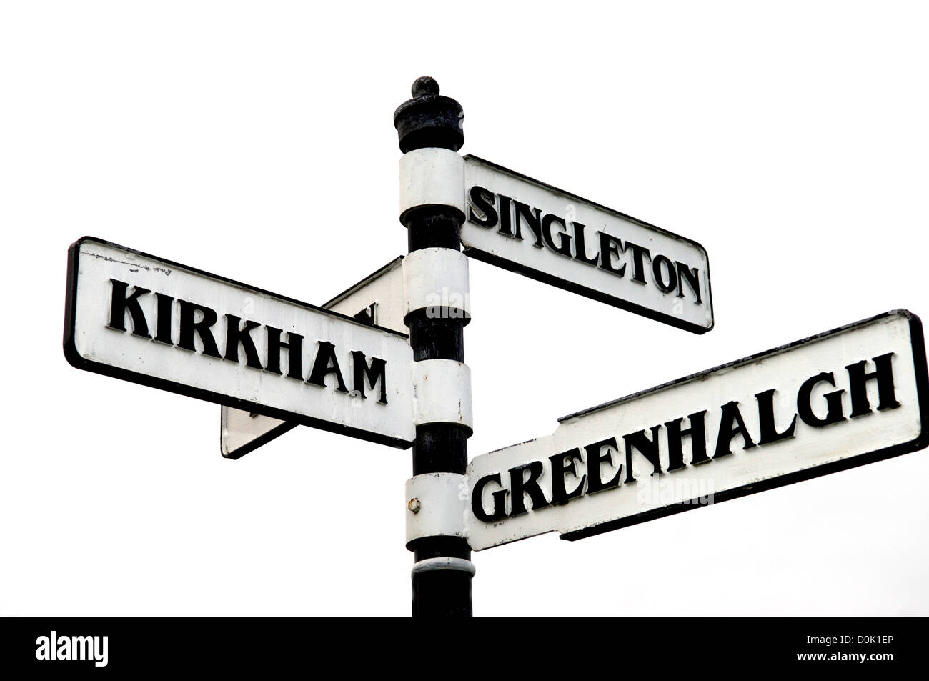 Black and white road direction sign against white sky in rural Fylde ...