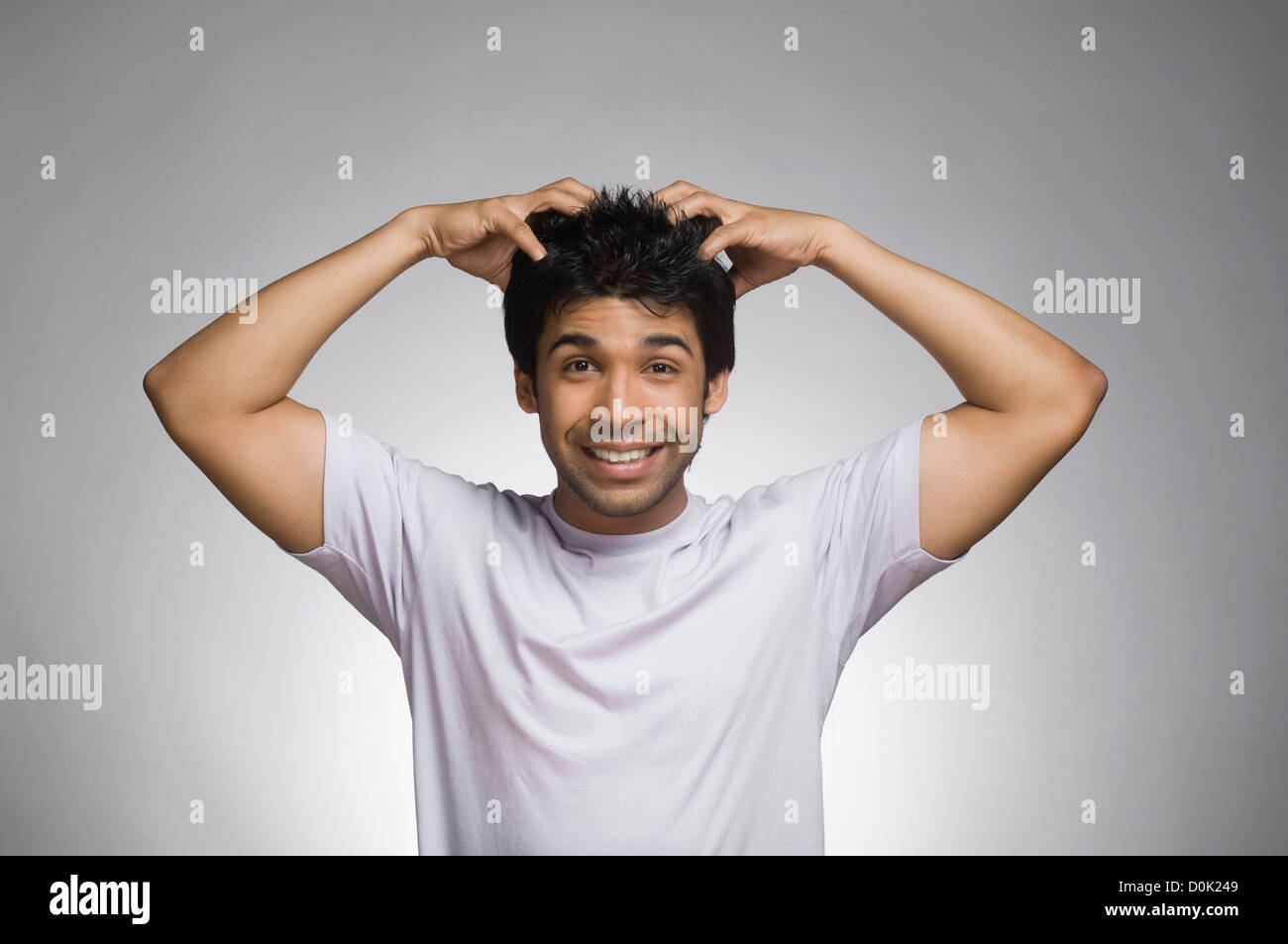 Man making a face with his hands in hair Stock Photo - Alamy