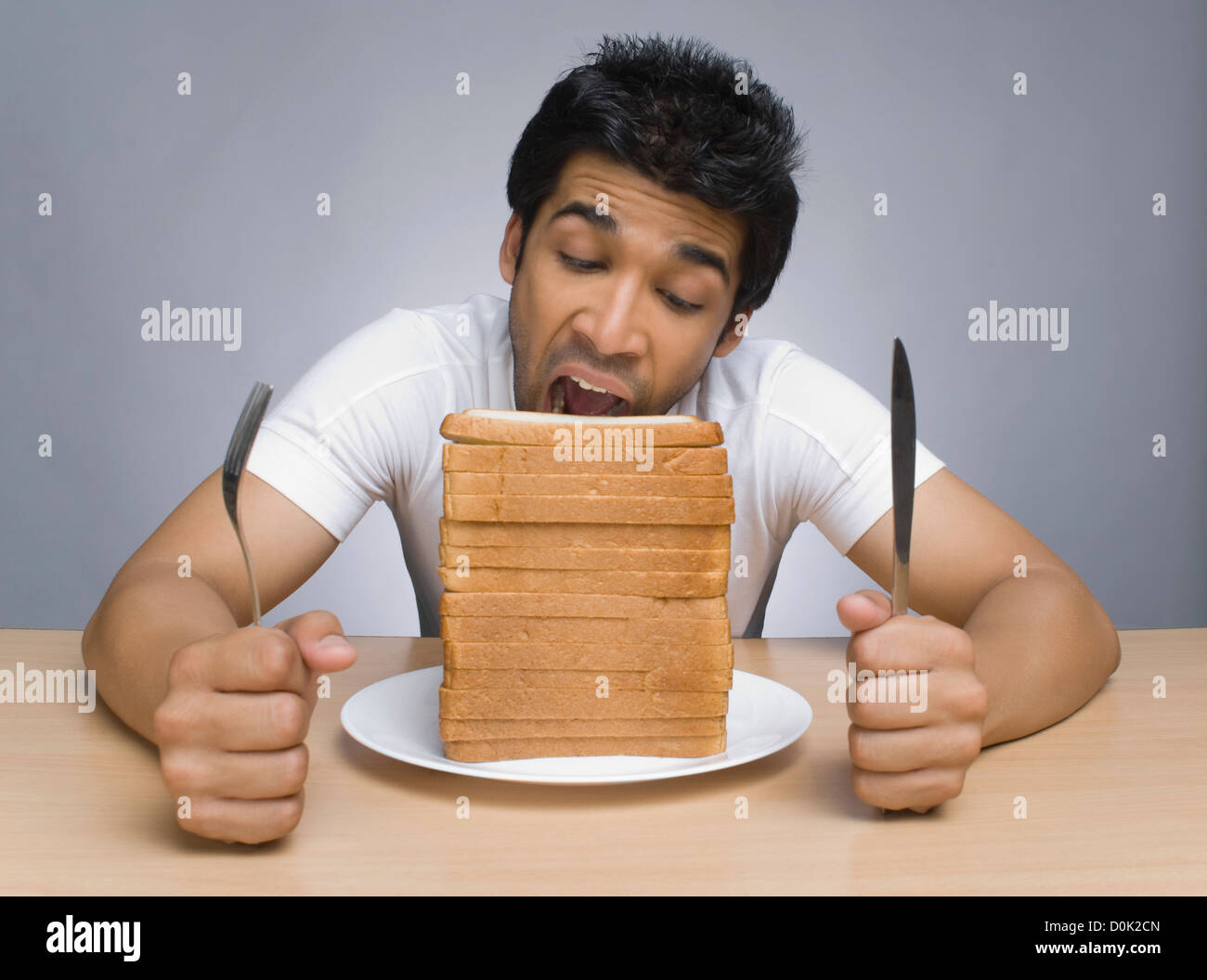 Man eating slices of bread Stock Photo - Alamy