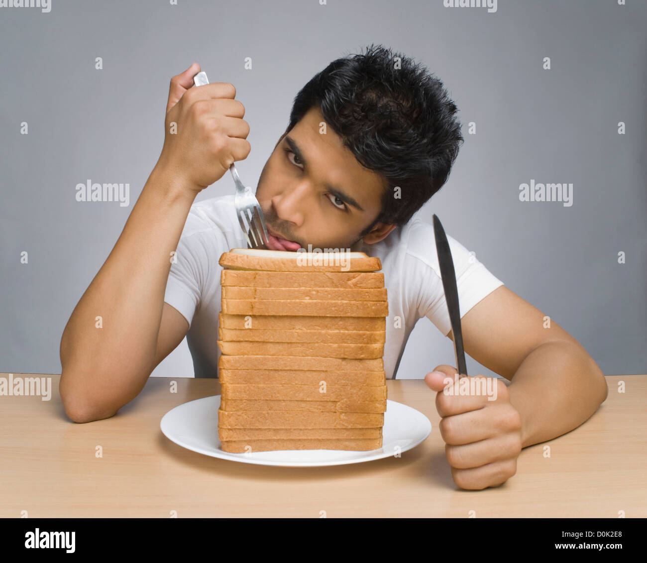 Man licking lips in front of slices of bread Stock Photo - Alamy