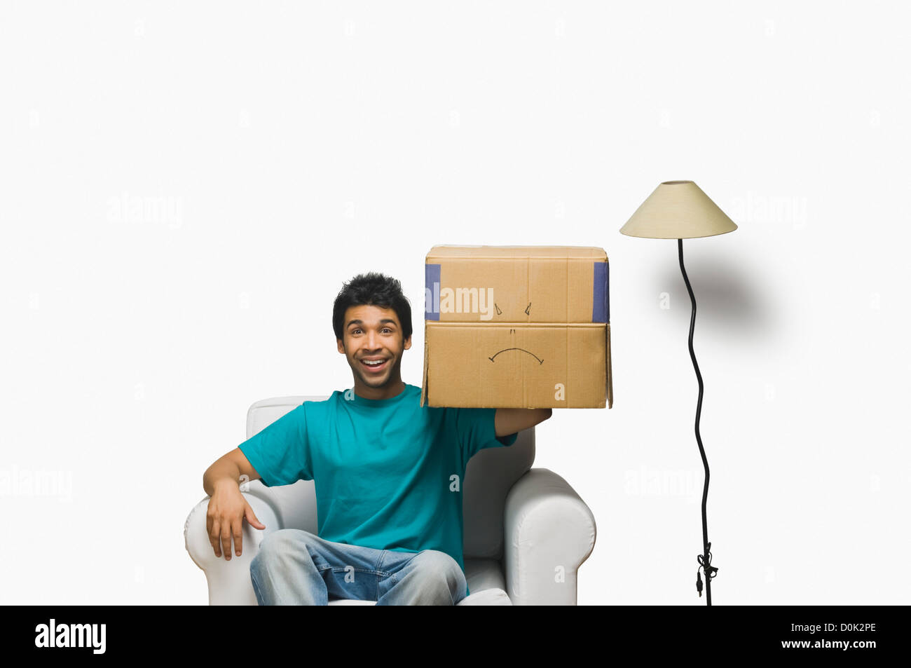 Man holding a cardboard box and smiling Stock Photo - Alamy