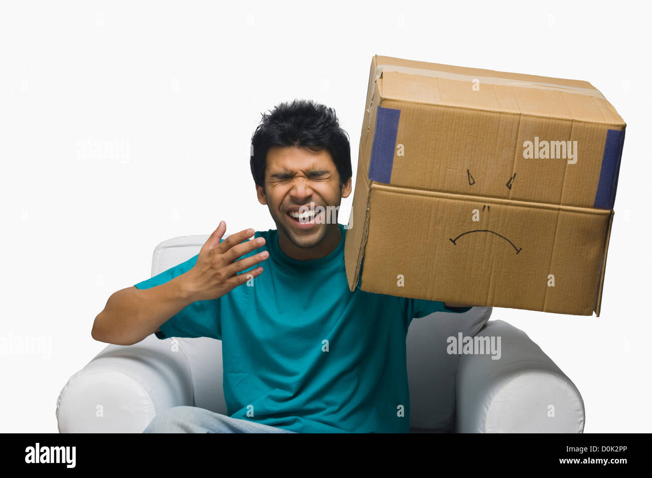 Man holding a cardboard box with a smiley face and laughing Stock Photo ...