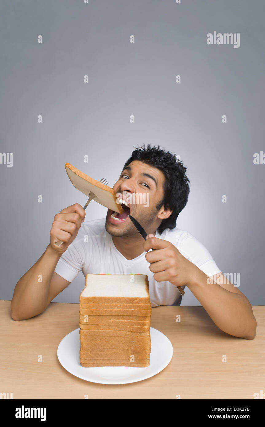 Man eating a slice of bread Stock Photo - Alamy