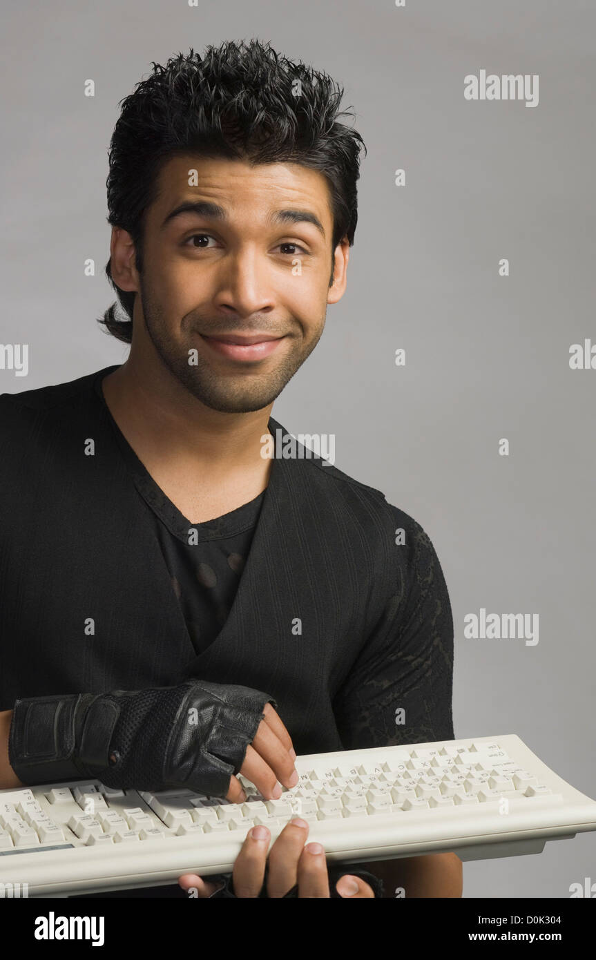 Happy man typing on a computer keyboard Stock Photo - Alamy