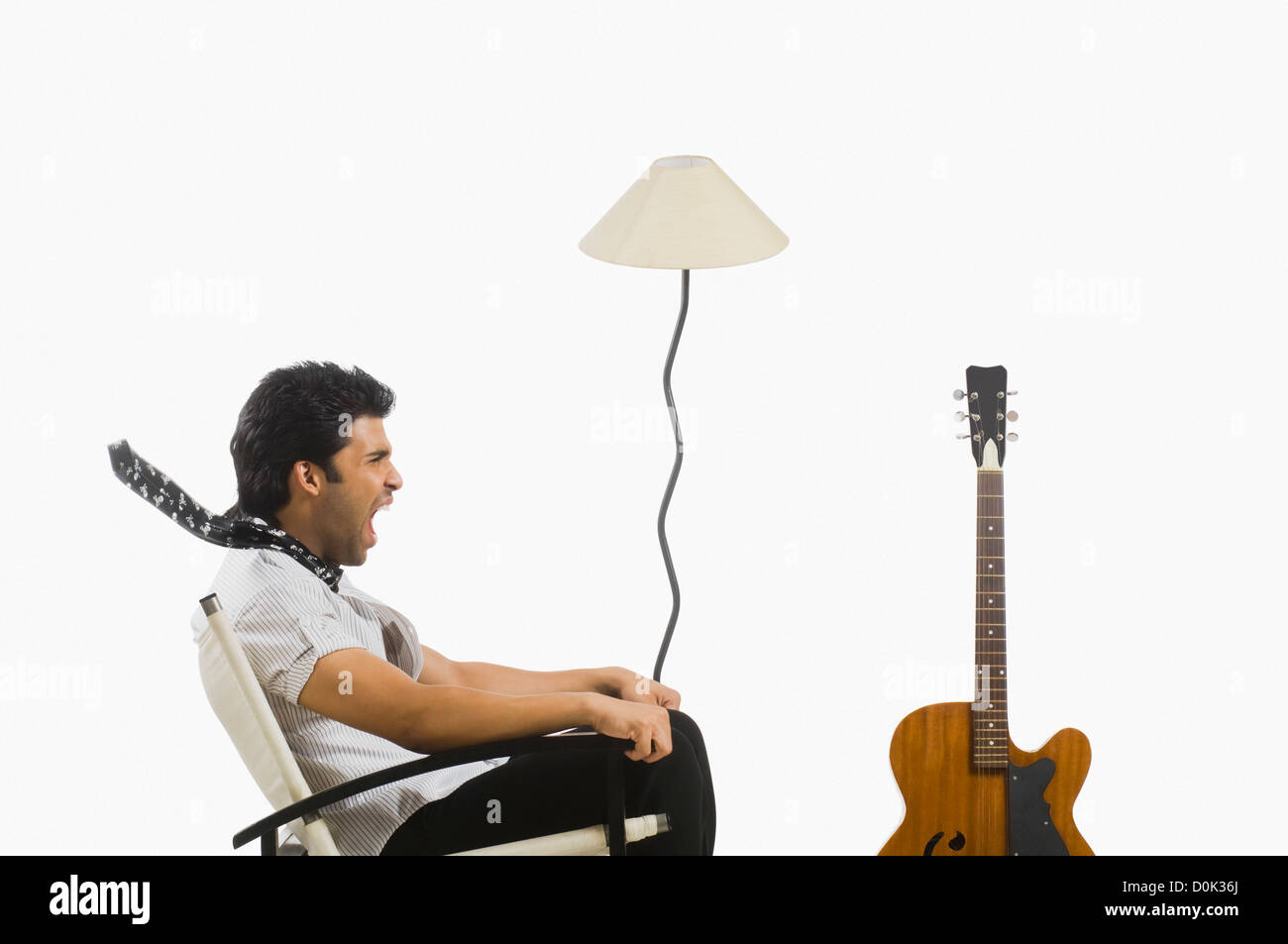 Man sitting in a chair and screaming Stock Photo - Alamy