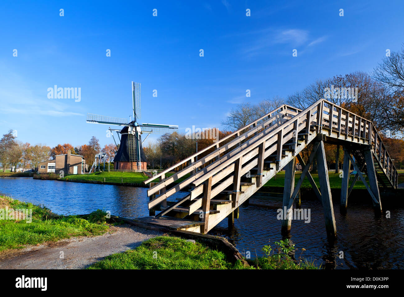 wooden Dutch windmill and bridge over blue sky Stock Photo - Alamy