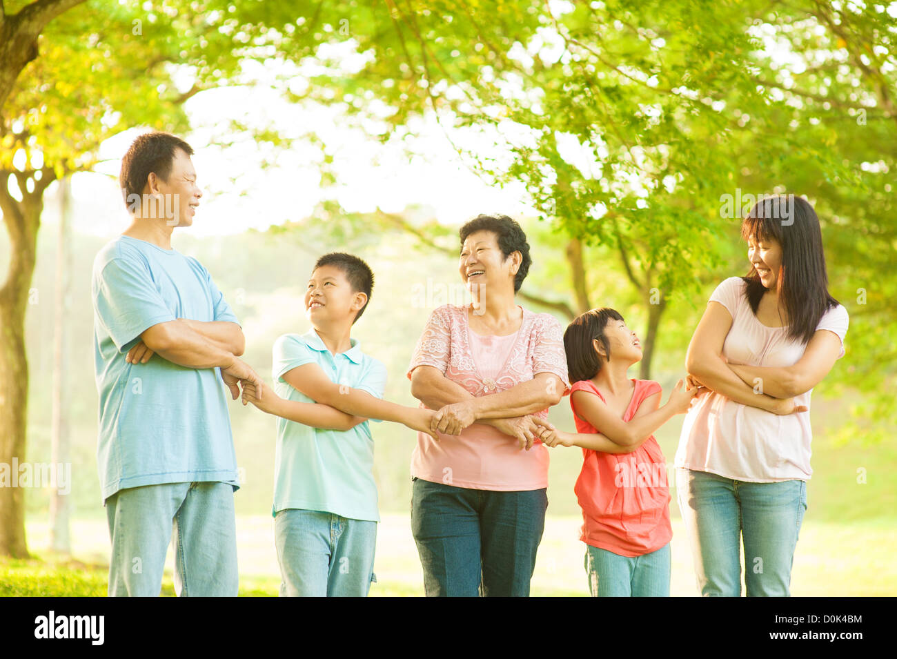 Three generations Asian family holding hands at outdoor park Stock ...