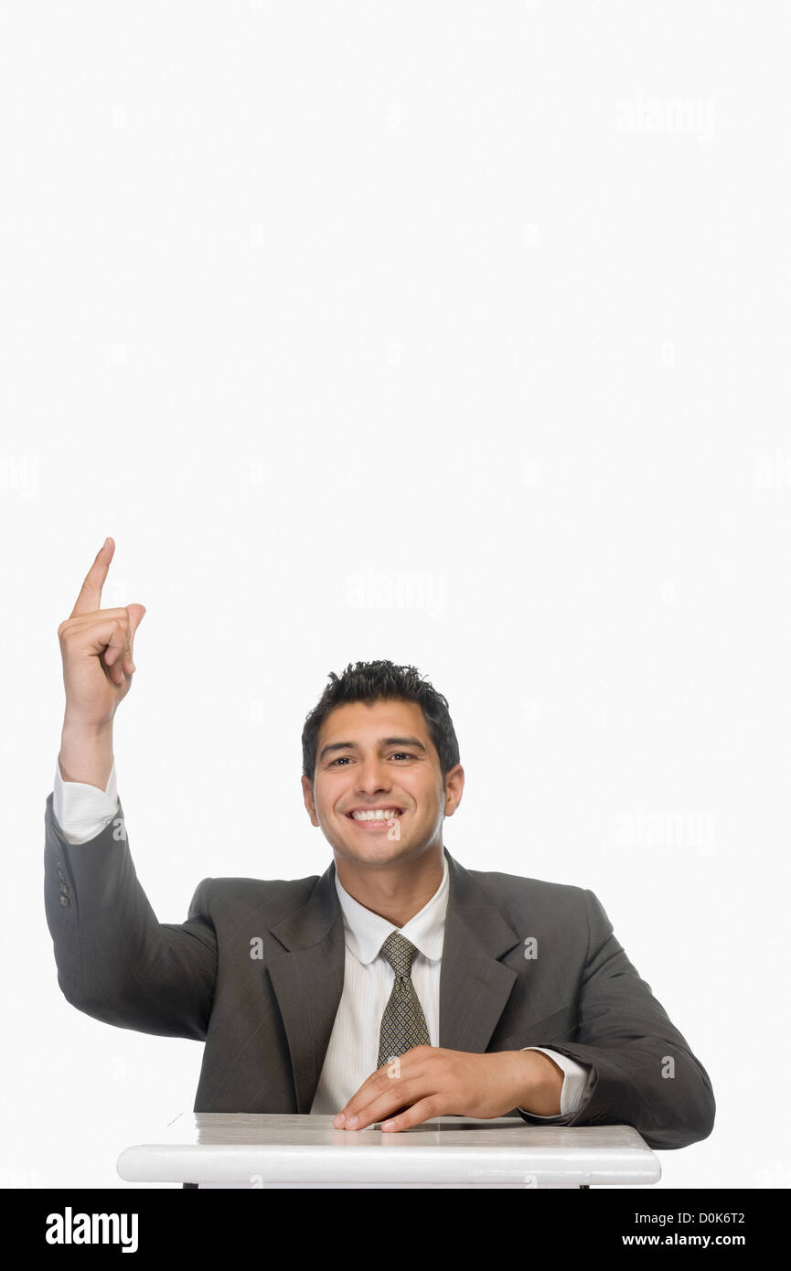 Portrait of a businessman indicating upward and smiling Stock Photo - Alamy