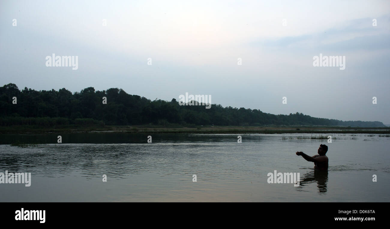 man offering prayers while bathing in a river in India Stock Photo - Alamy