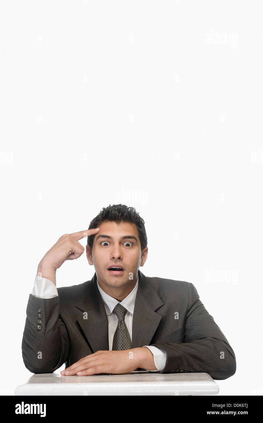 Portrait of a businessman thinking with his eyes wide open Stock Photo ...