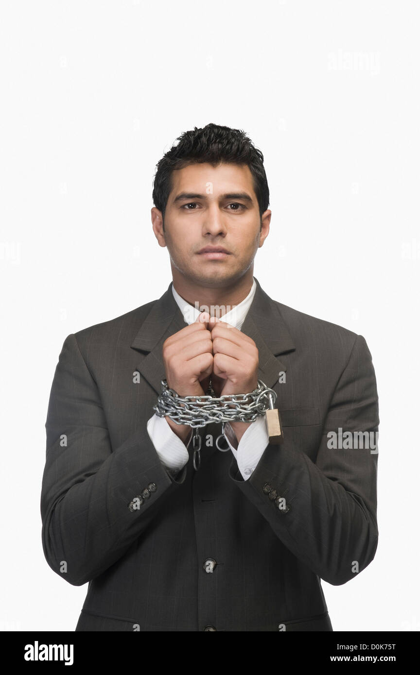 Portrait of a businessman locked with chains Stock Photo - Alamy