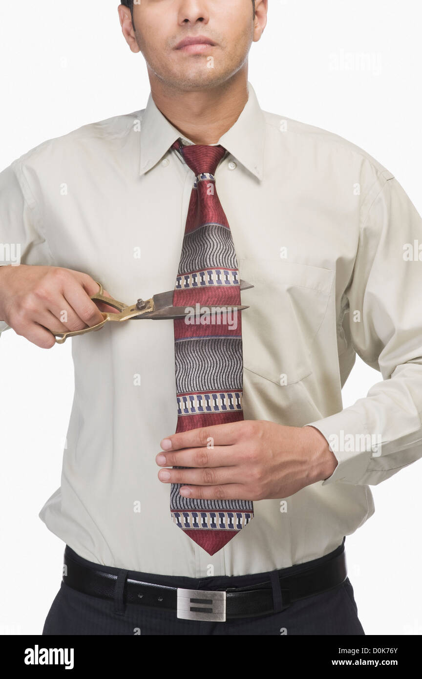 Businessman cutting his tie by scissors Stock Photo - Alamy