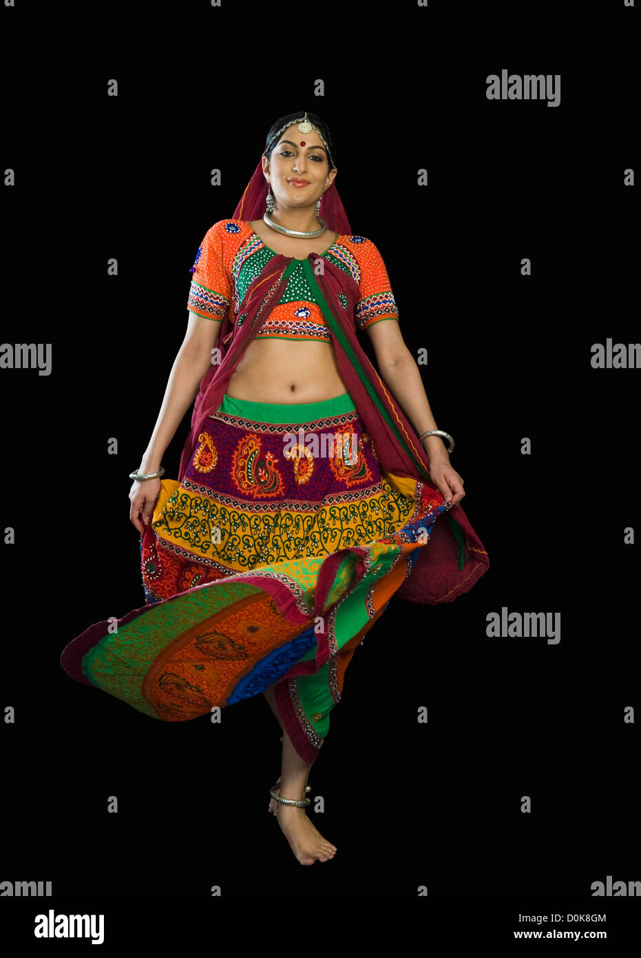 Woman in colorful lehenga choli dancing Stock Photo - Alamy