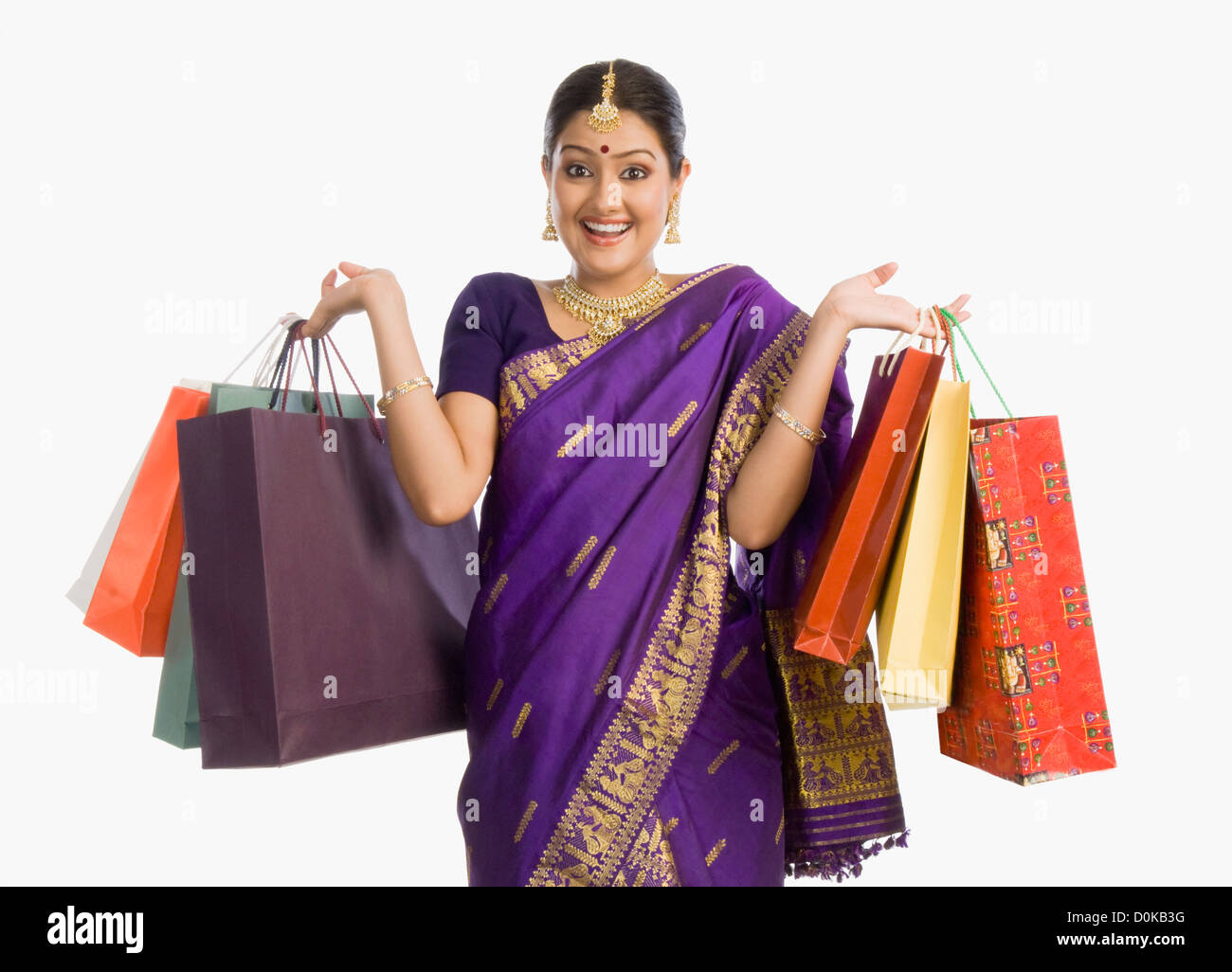 Beautiful Assamese woman holding shopping bags and smiling Stock Photo ...
